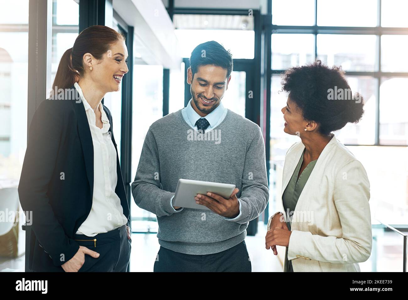 Smart technology for a smart team. a diverse group of young colleagues using a digital tablet ...