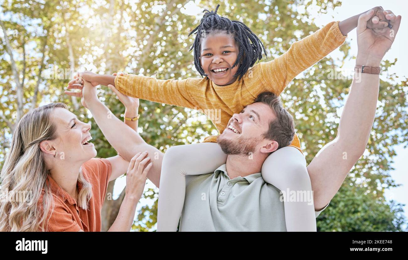 Family, adoption and piggyback in the park with a girl and foster ...