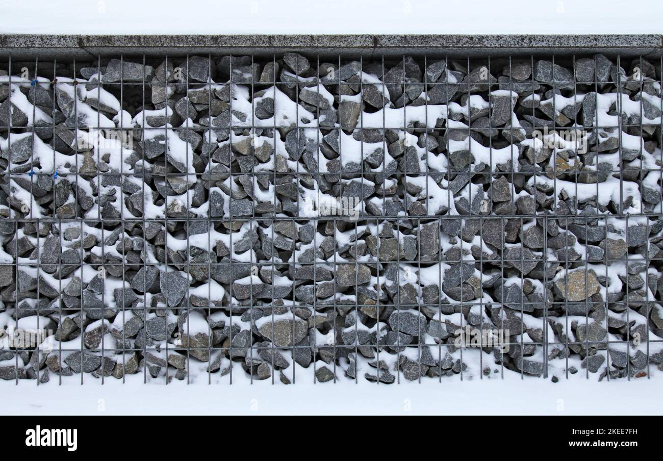 Gabion, texture, background. Snow covered gabion net and stone fencing ...