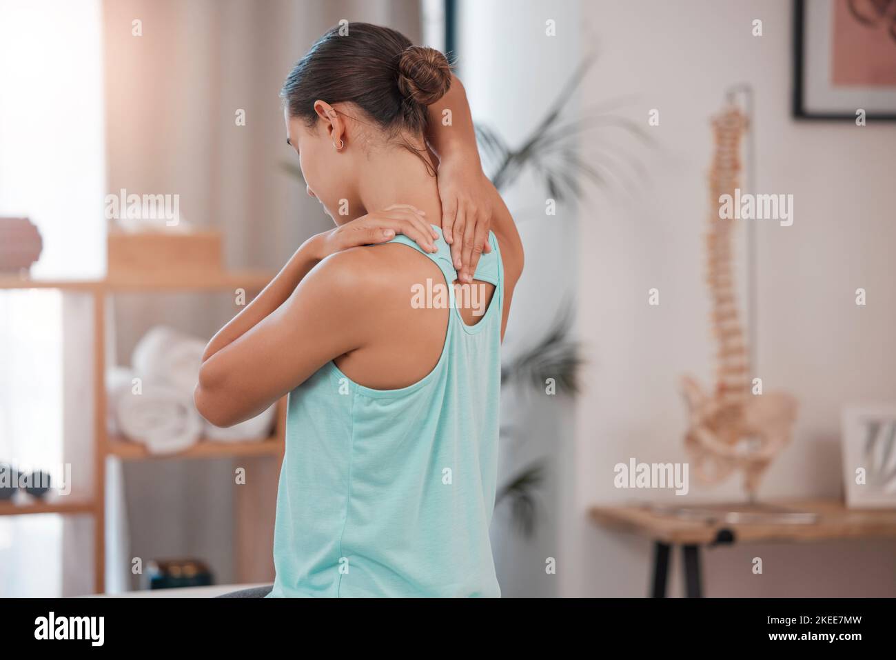 Chiropractor, physiotherapy and injury with a woman client stretching ...