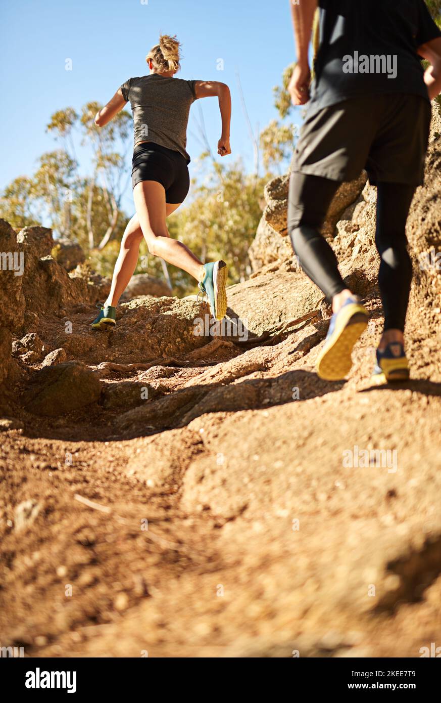 Time for a trail run. a young couple out for a trail run Stock Photo ...
