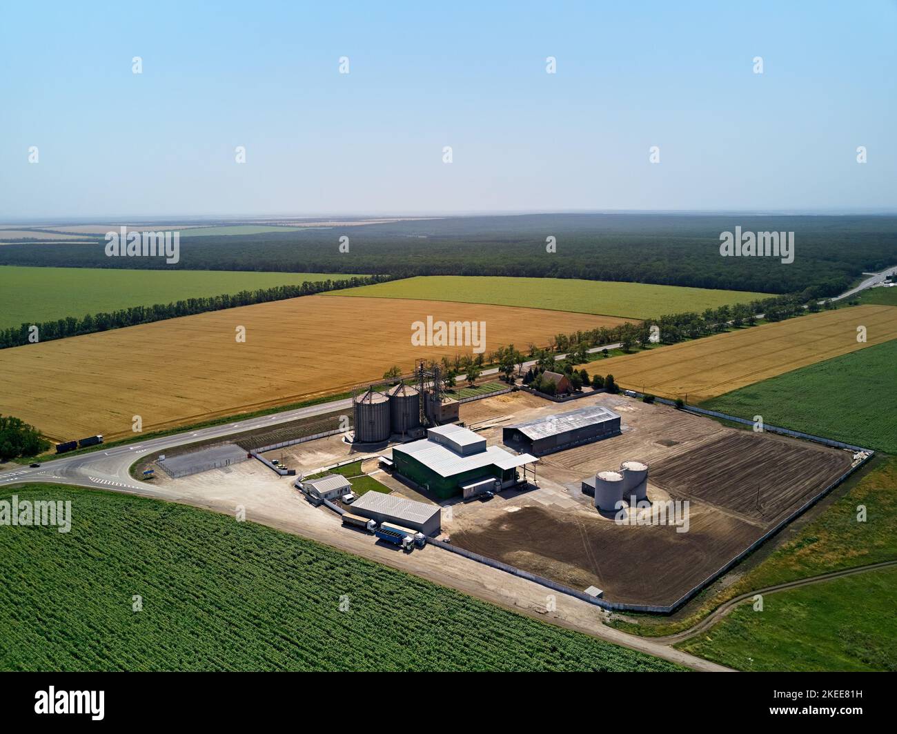 Aerial of grain elevator in front of wheat field. Drone photo above ...