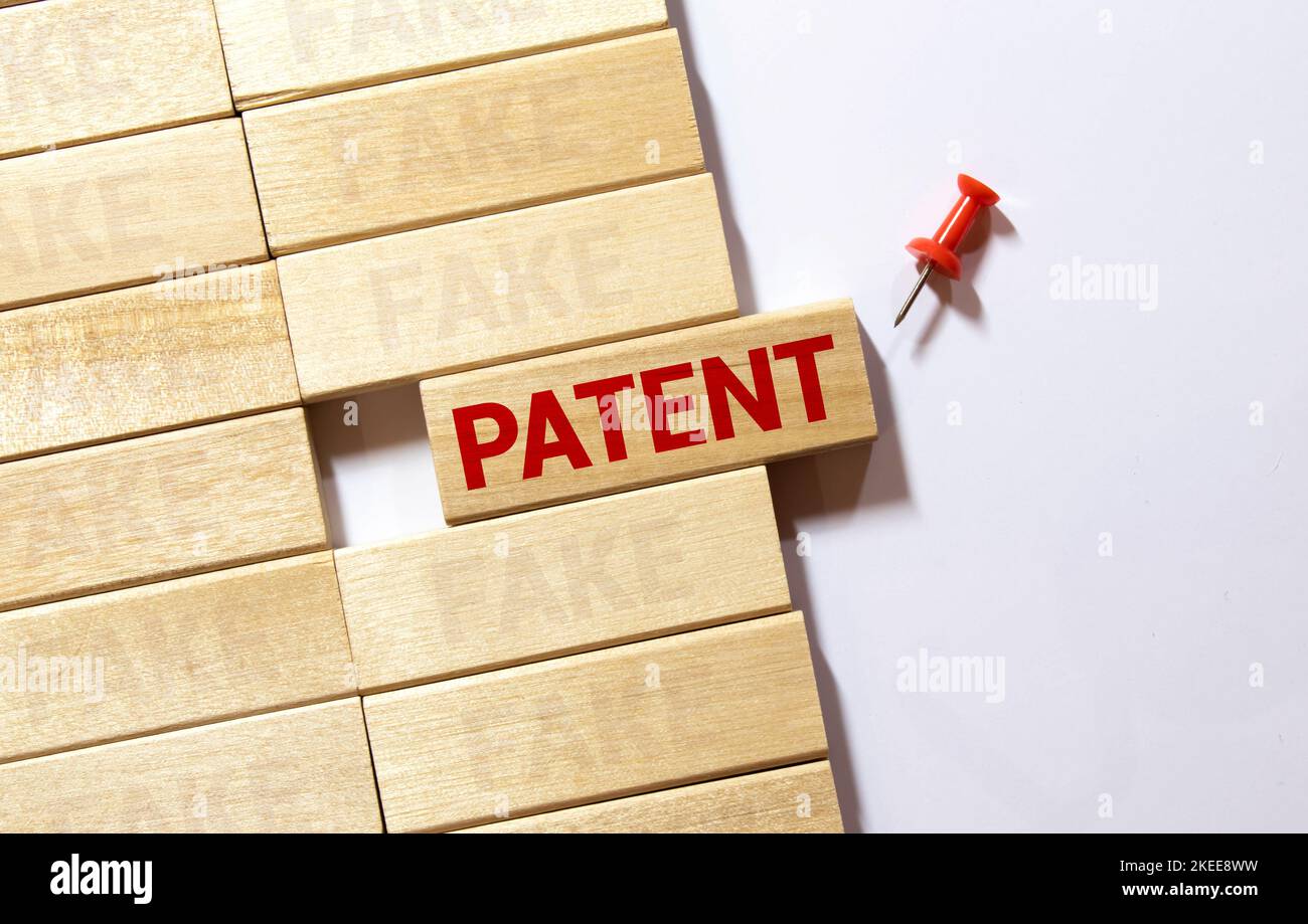 Blue color ink rubber stamp in word patent on white paper background ...