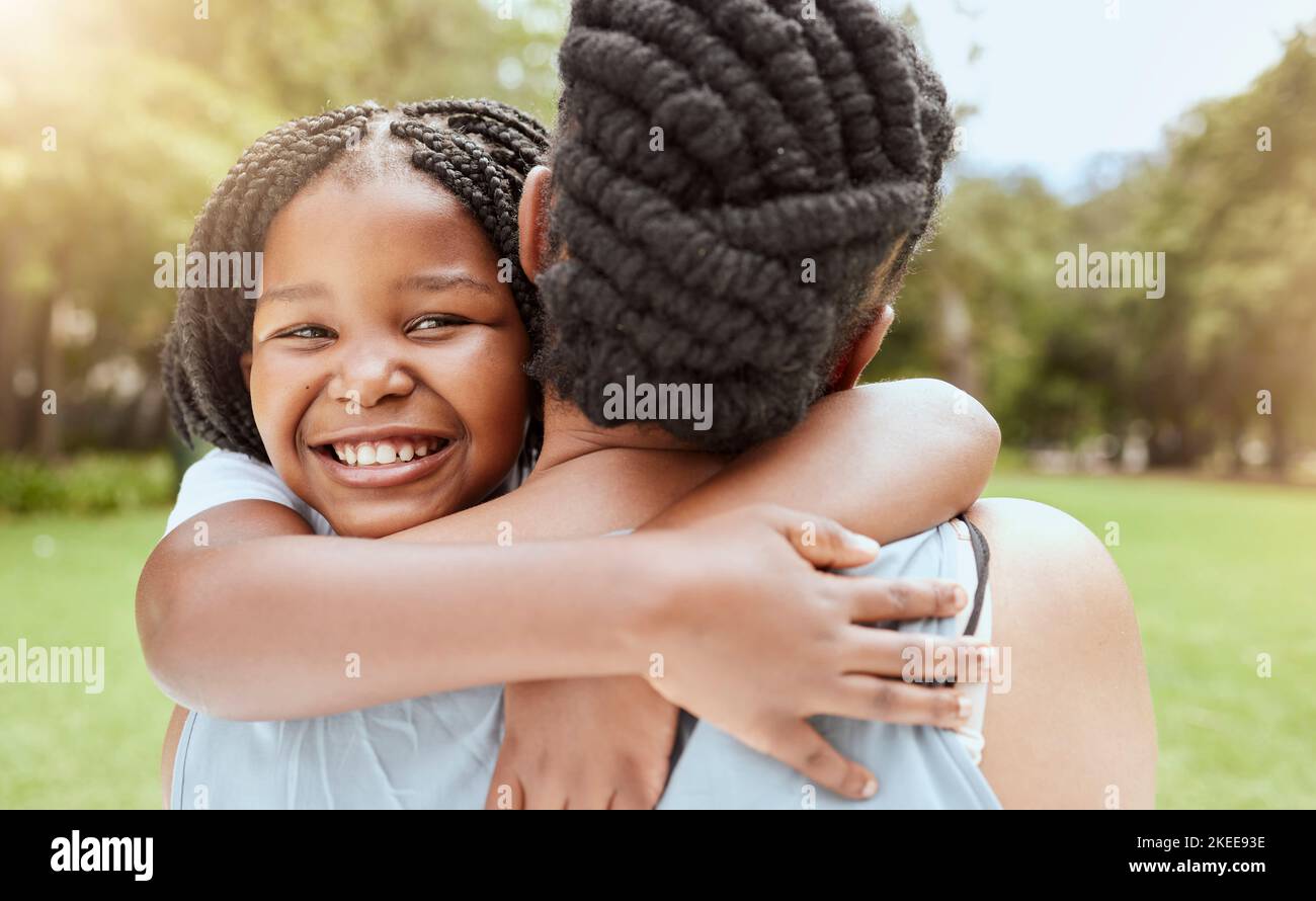 Family, children and hugging with a mother and daughter in a nature park or garden while ...