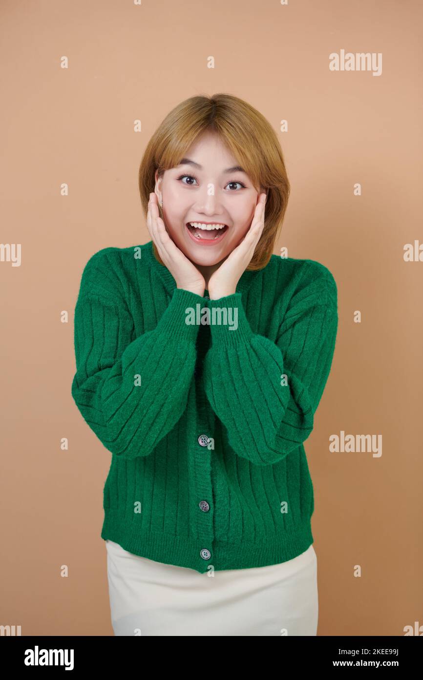 Young Asian woman with surprised excited happy screaming. Cheerful girl ...