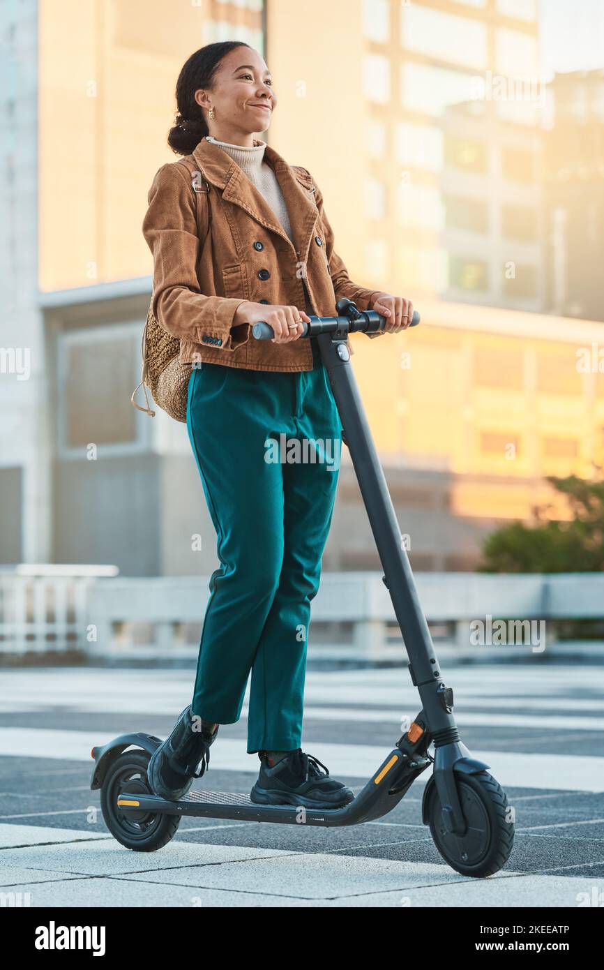 Electrical scooter, woman and city travel on eco friendly ...