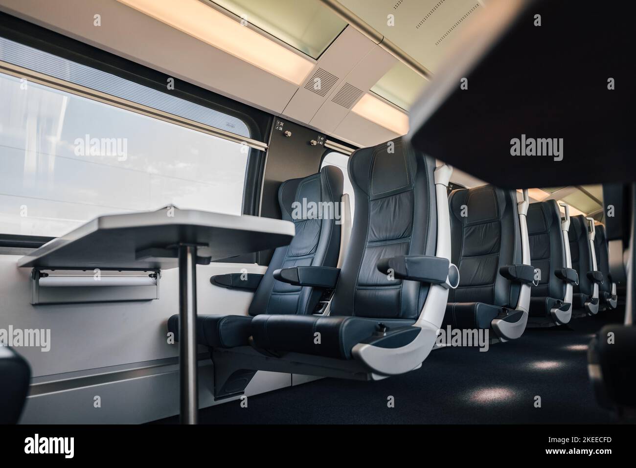 View of table and empty seats by window. Interior of modern high speed ...