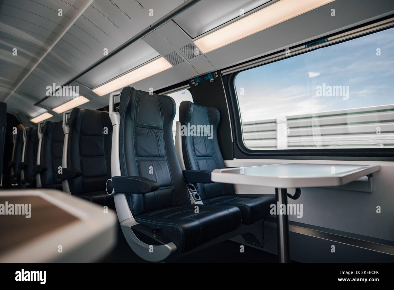 Table and empty leather seats by window. Interior of Intercity ...