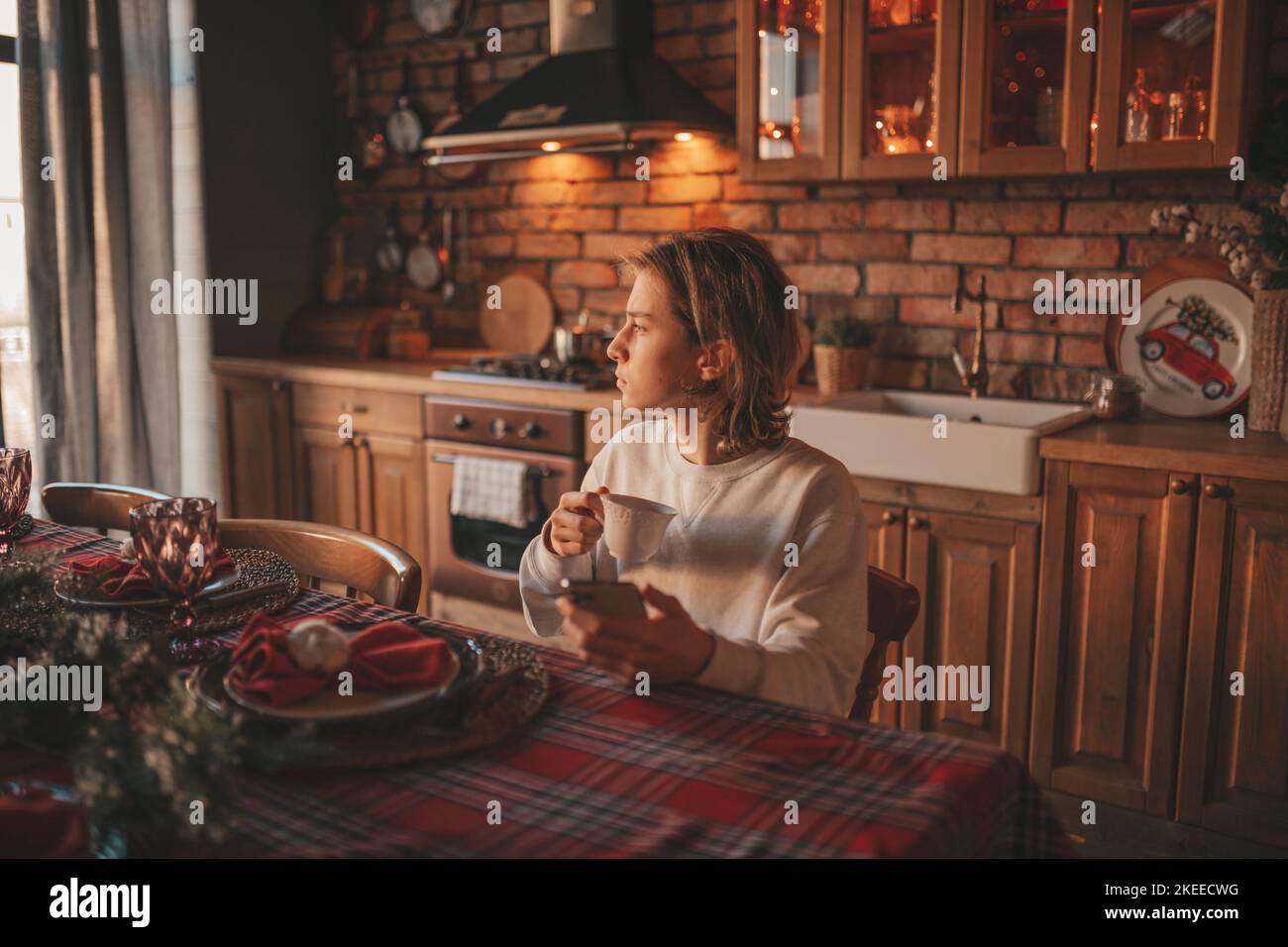 Young teen boy with long hair thoughtful look sad eyes negative mood ...