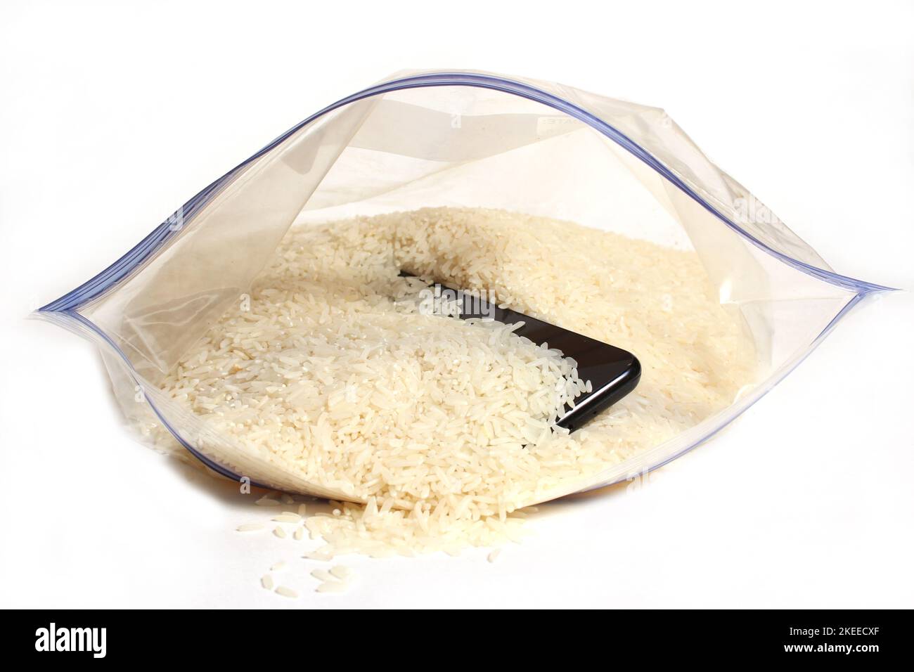 Smartphone in Bag of Rice to remove water from phone Stock Photo - Alamy