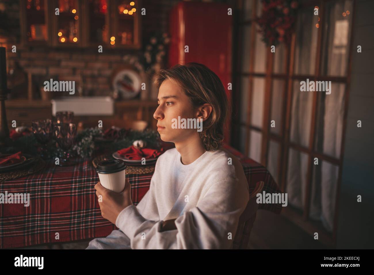 Young teen boy with long hair thoughtful look sad eyes negative mood ...