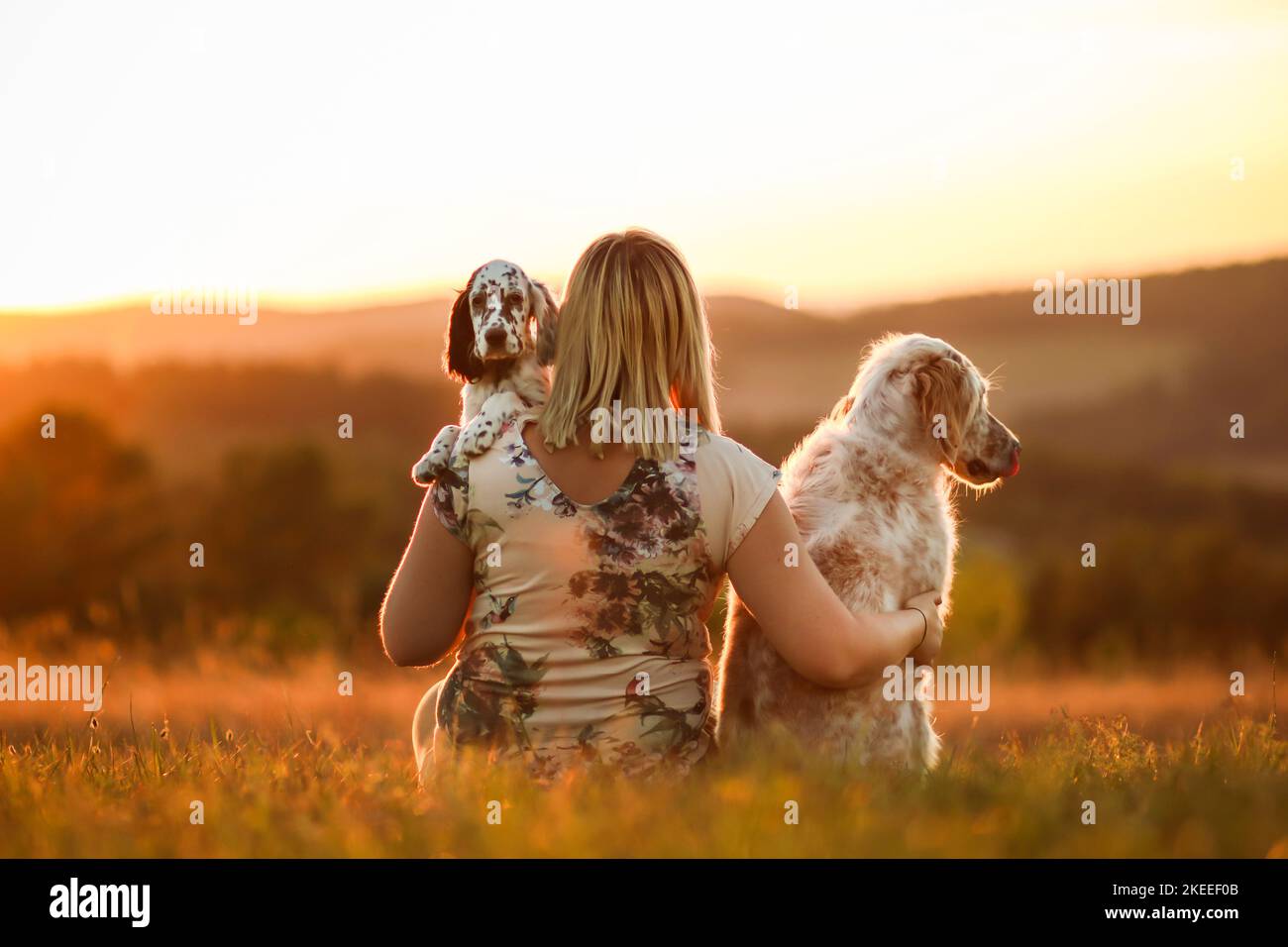 Woman stroking dog sunrise outdoor hi-res stock photography and images ...