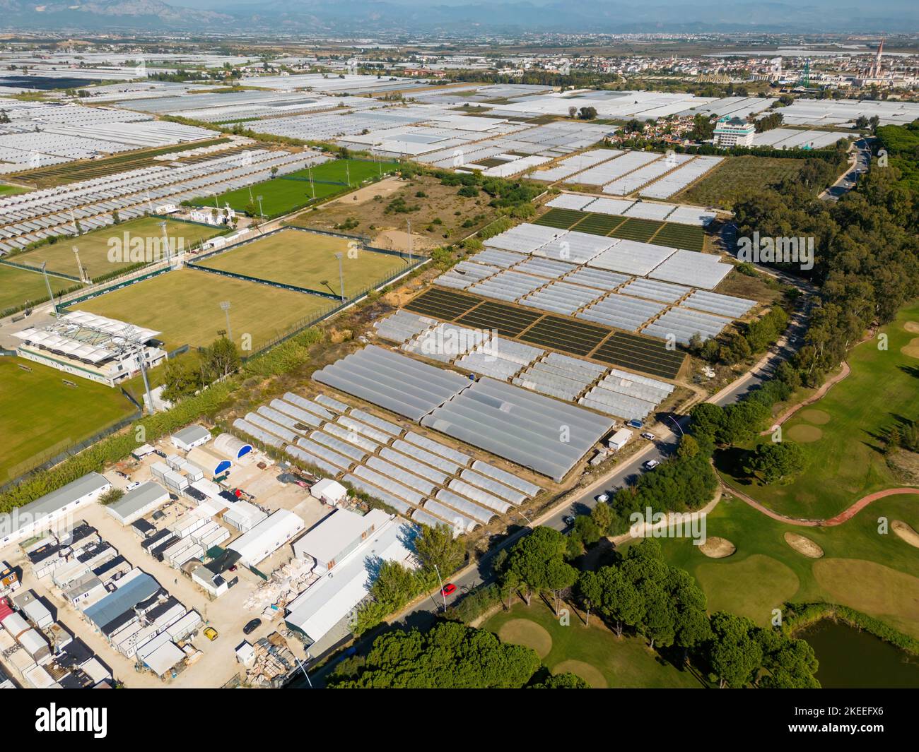 Aerial views of rows of greenhouses taken by drone. Greenhouse roofs ...