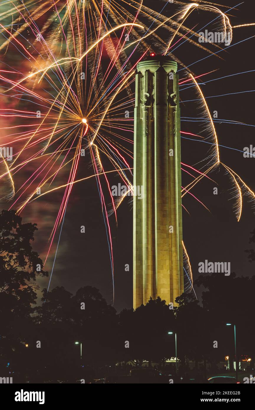 A vertical shot of exploding fireworks over the National WWI Memorial ...