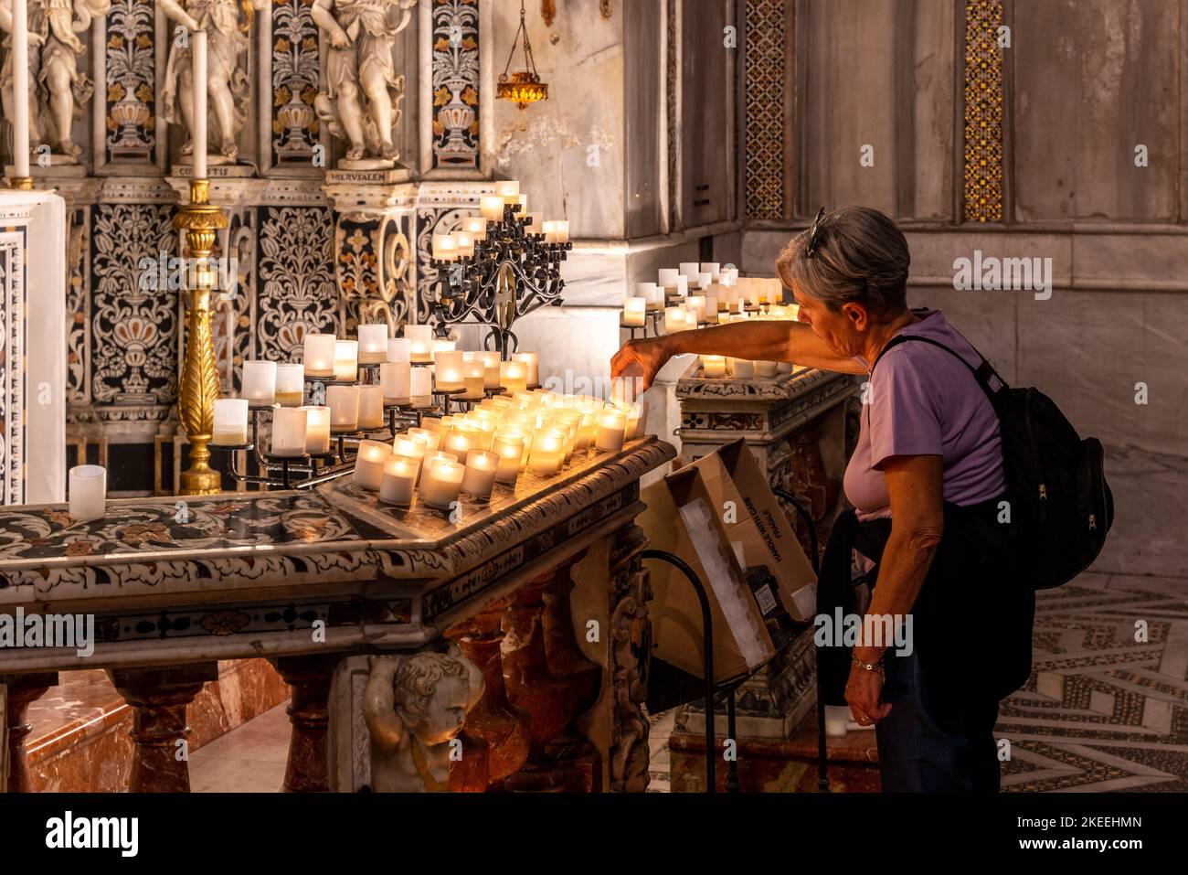 Woman lighting candle at duomo hi-res stock photography and images - Alamy