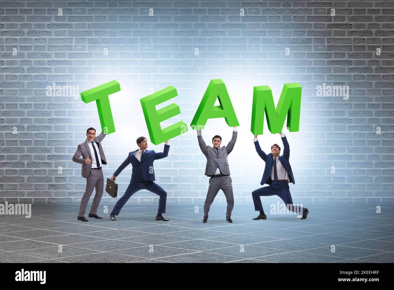 Teamwork concept with the people carrying team letters Stock Photo - Alamy