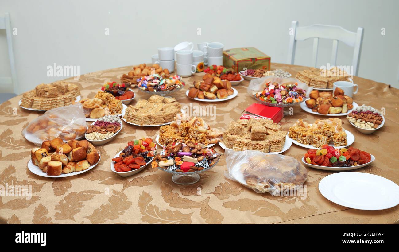 A variety oriental sweets on table in cafe, treats for dear guests ...