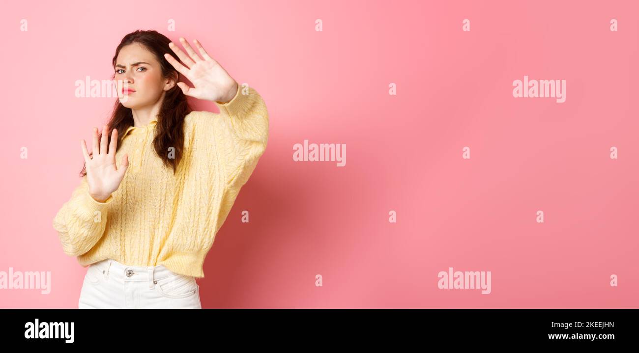 Please stop, enough. Displeased and reluctant young woman stay back ...