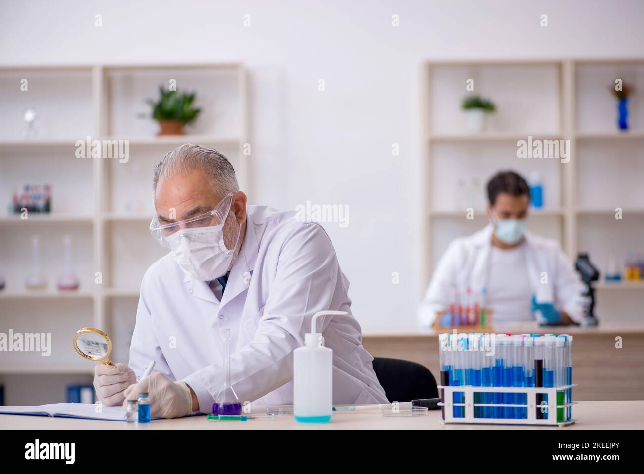 Two chemist working at the lab Stock Photo - Alamy