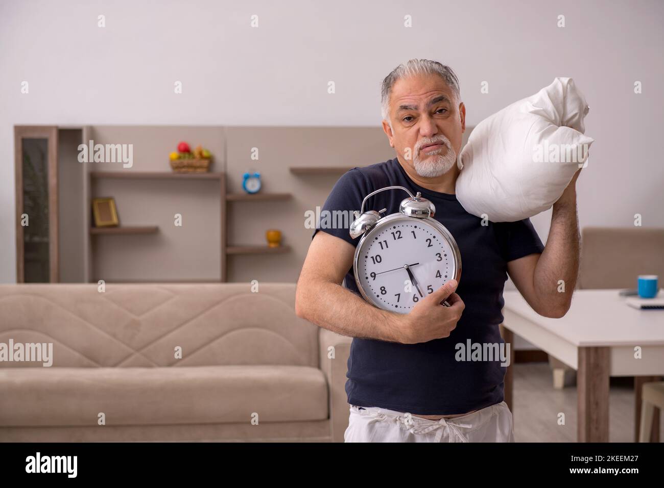 Old man doing sport exercises indoors Stock Photo - Alamy