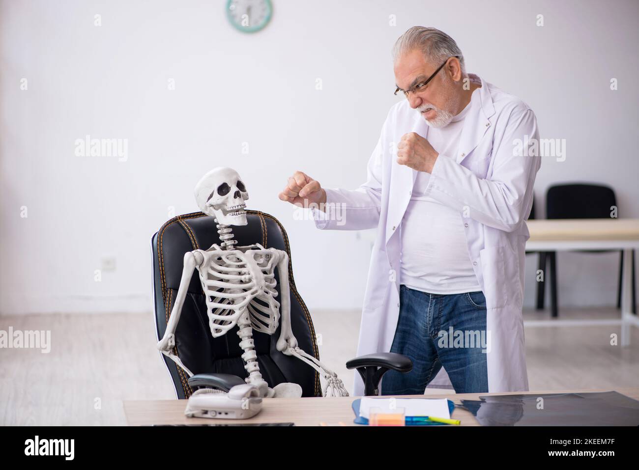 Old doctor with skeleton at the hospital Stock Photo - Alamy