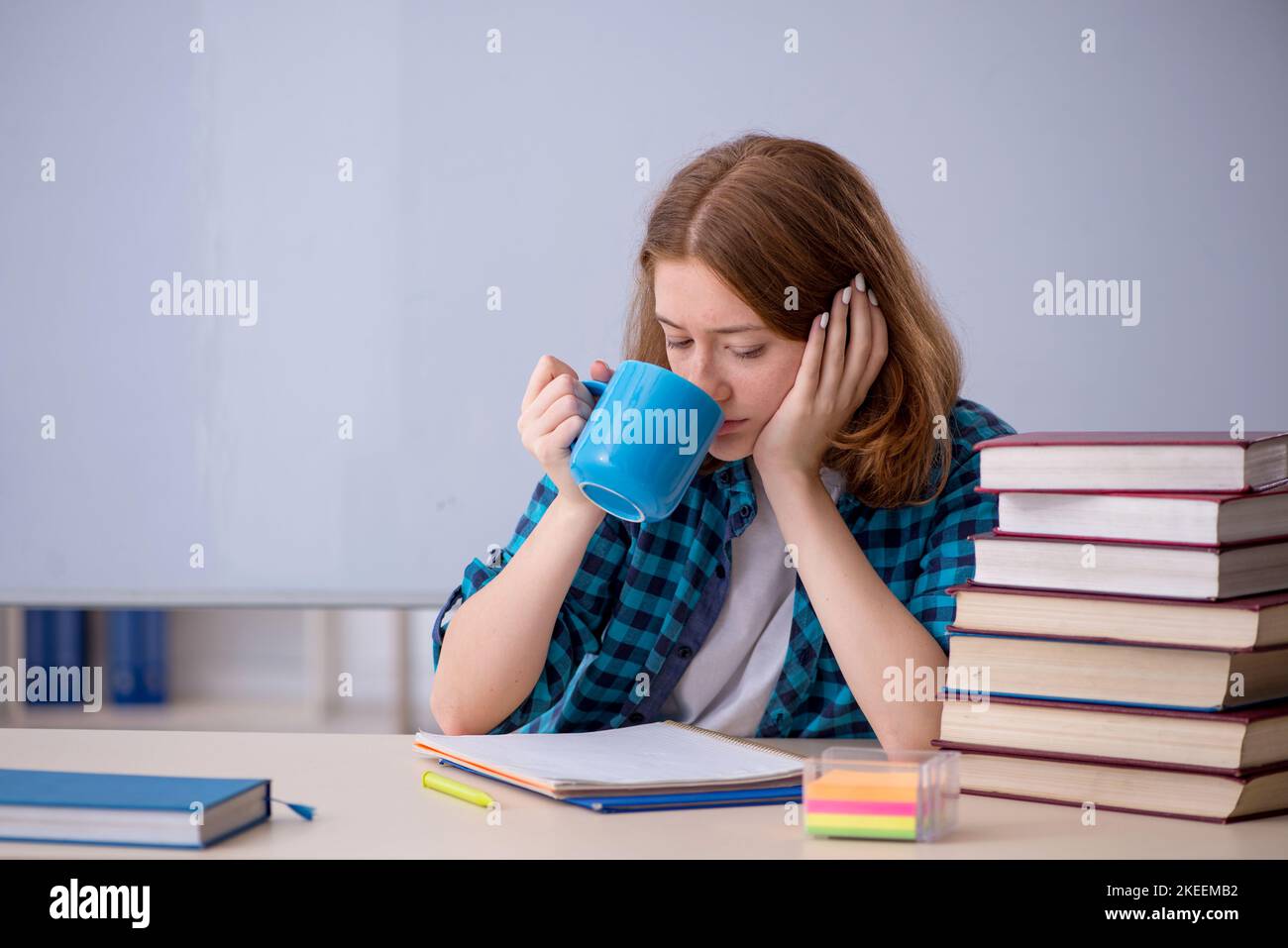 Young girl student drinking coffee during break Stock Photo - Alamy