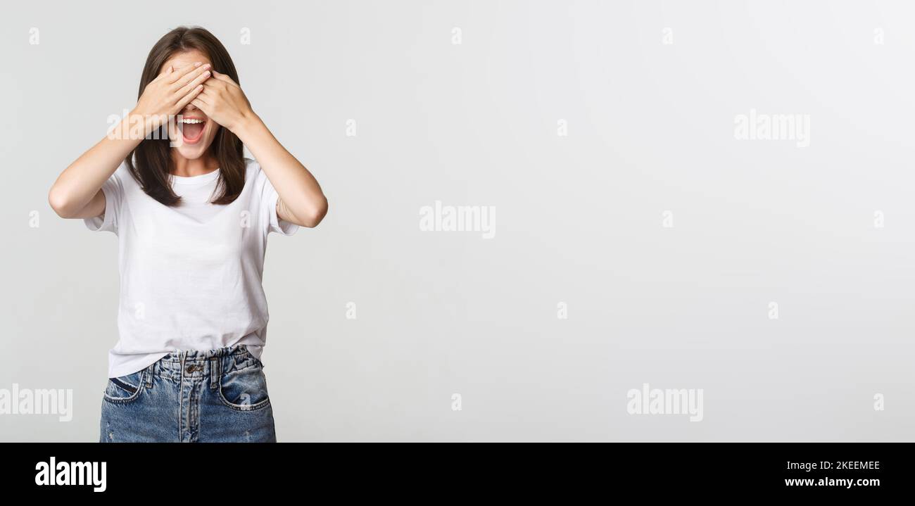 Cheerful smiling woman shut eyes and expect surprise Stock Photo - Alamy