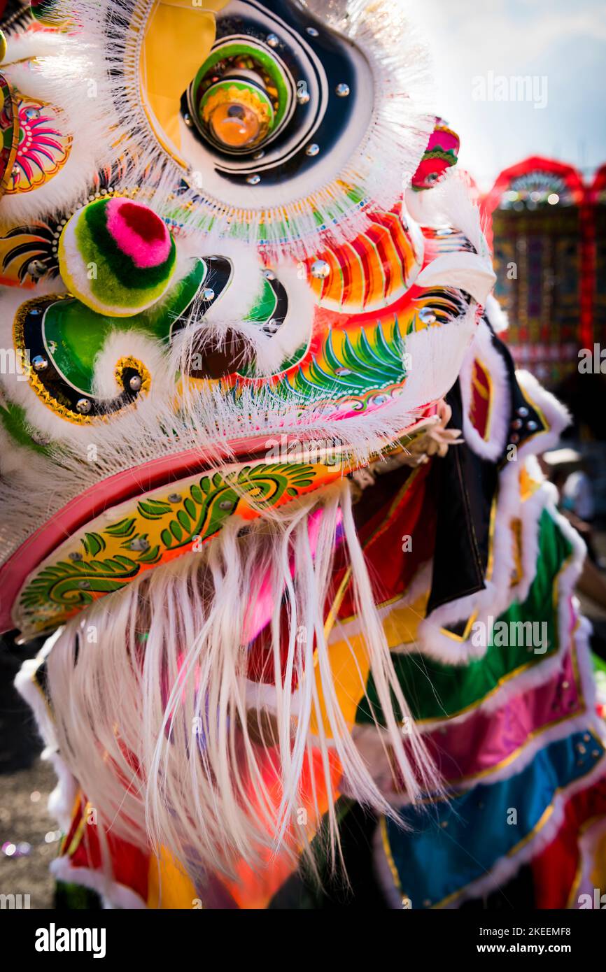 Close-up of the elaborate, colourful head of a lion dance puppet at the ...