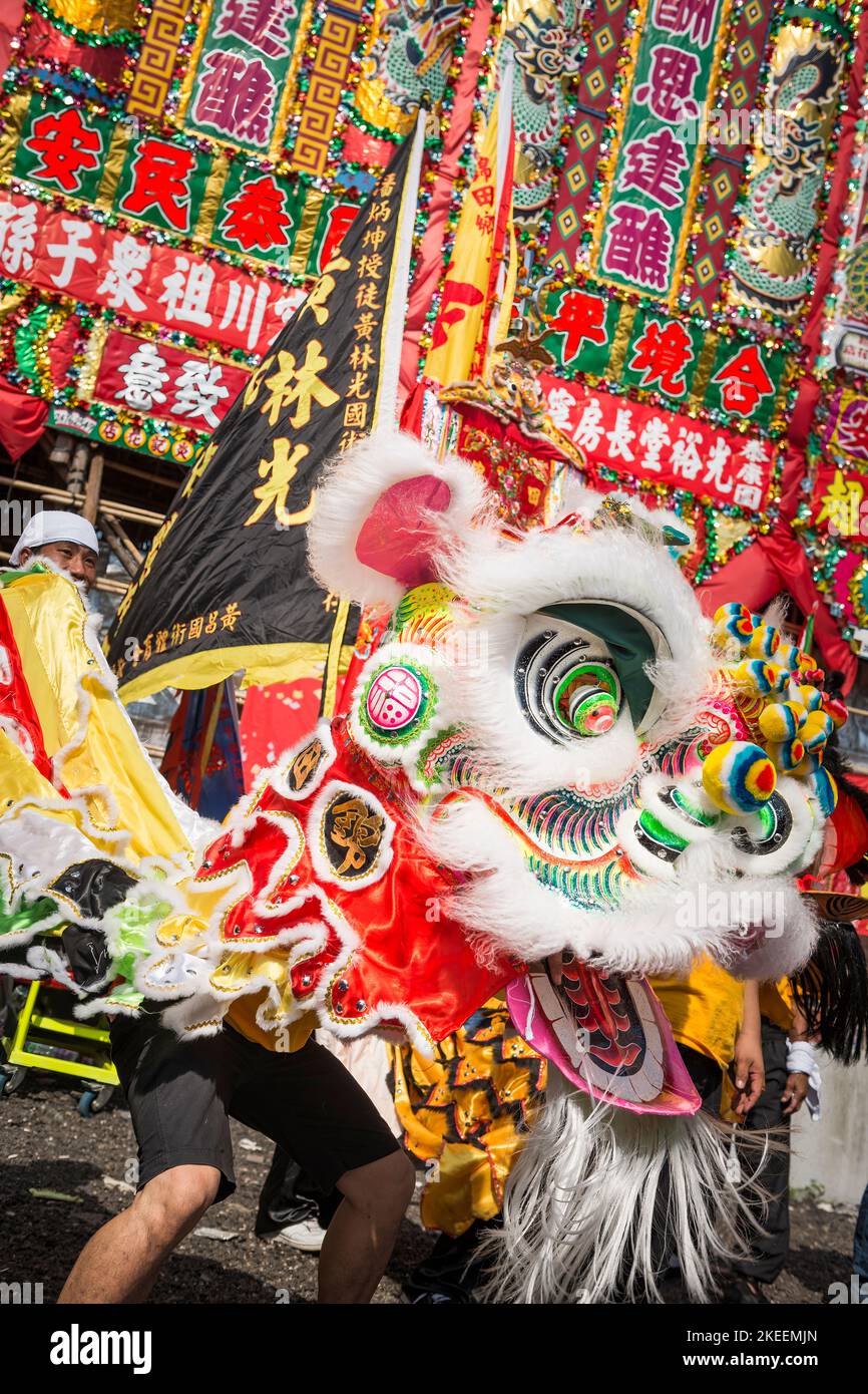 Lion dancers prepare to leave the Da Jiu festival site for a procession ...