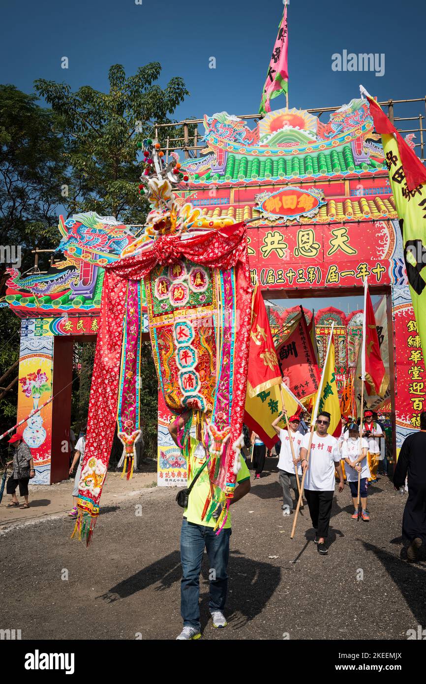 Villagers leave the decennial Da Jiu festival site for a procession ...