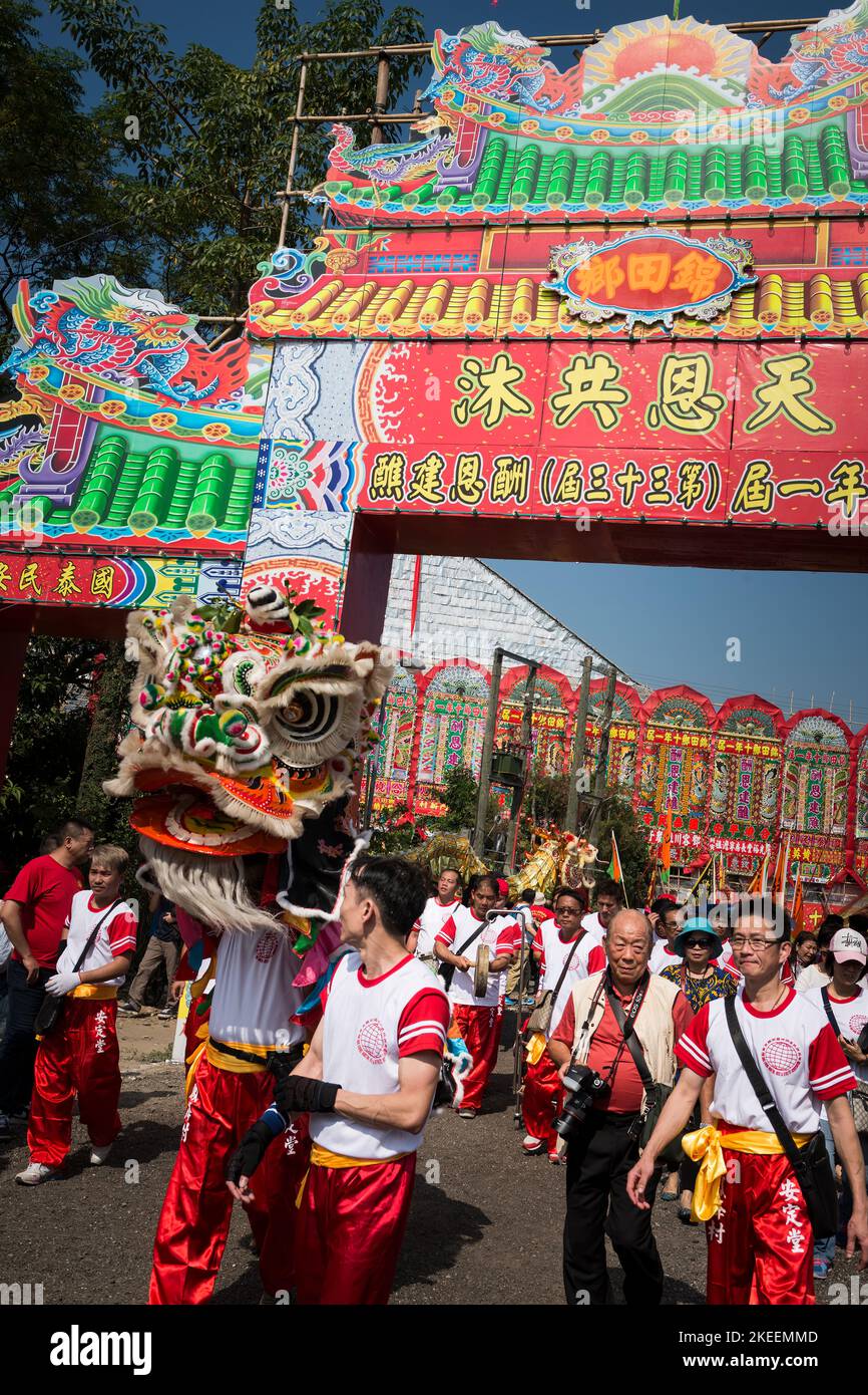 Lion dancers leave the decennial Da Jiu festival site for a procession ...