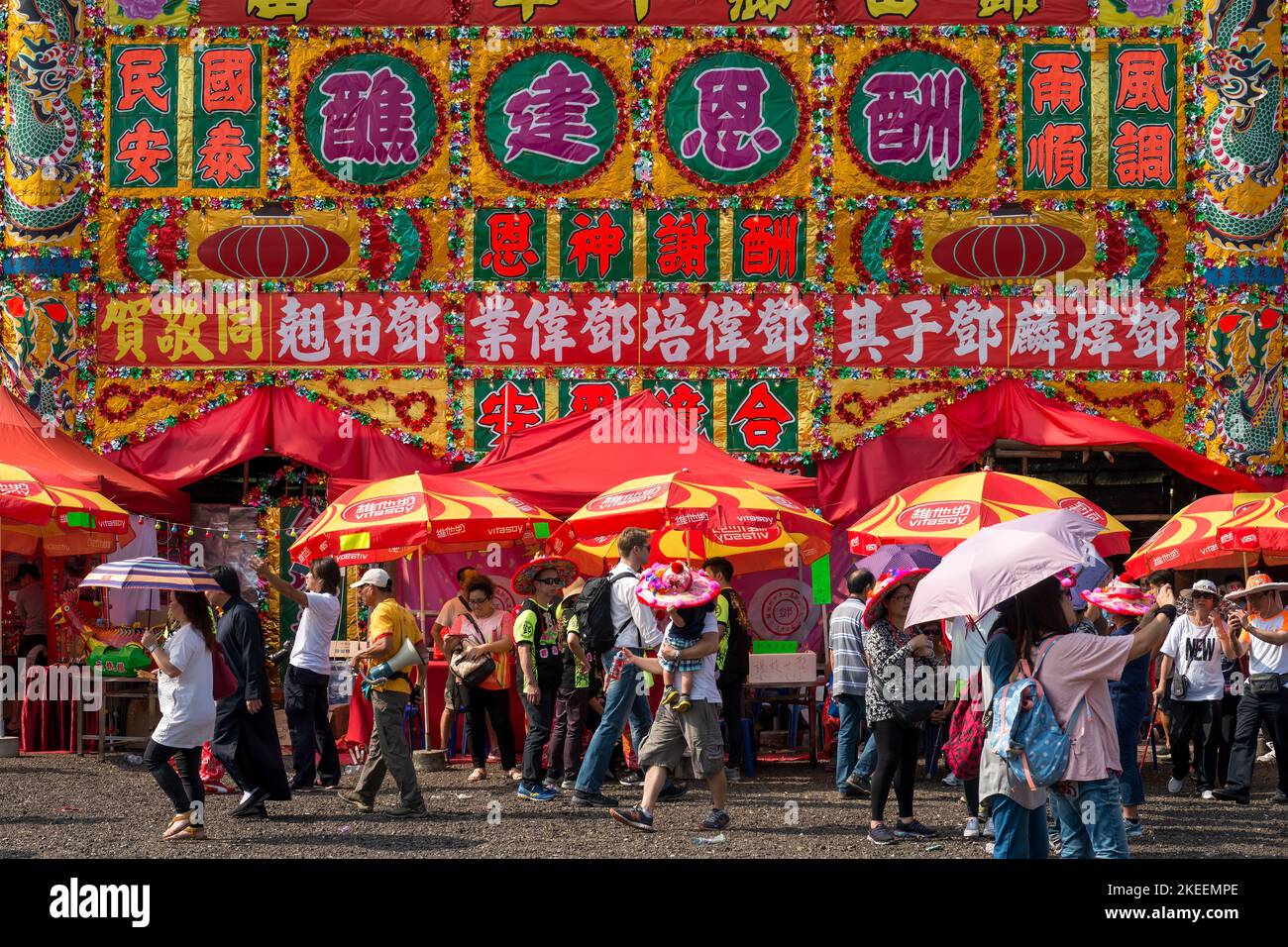 Villagers and visitors enjoy the sights in front of a section of a huge ...