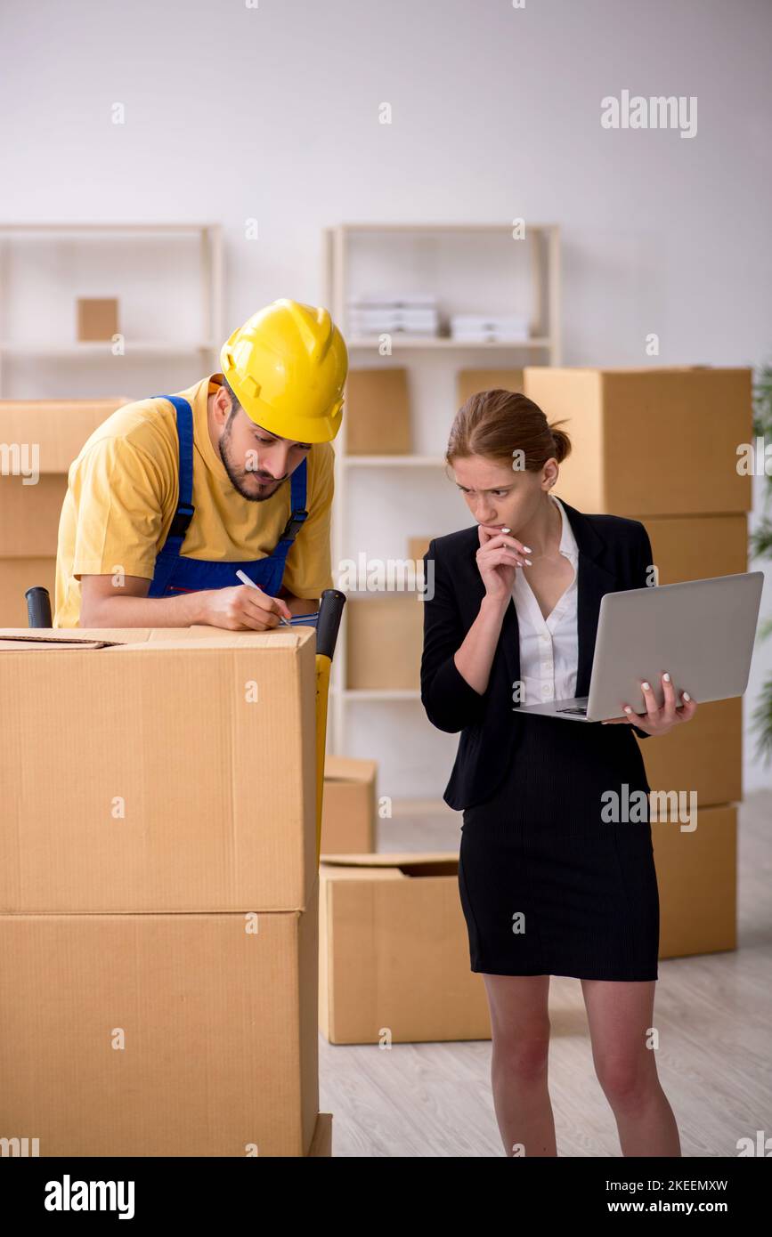 Female boss and male contractor doing home relocation Stock Photo - Alamy