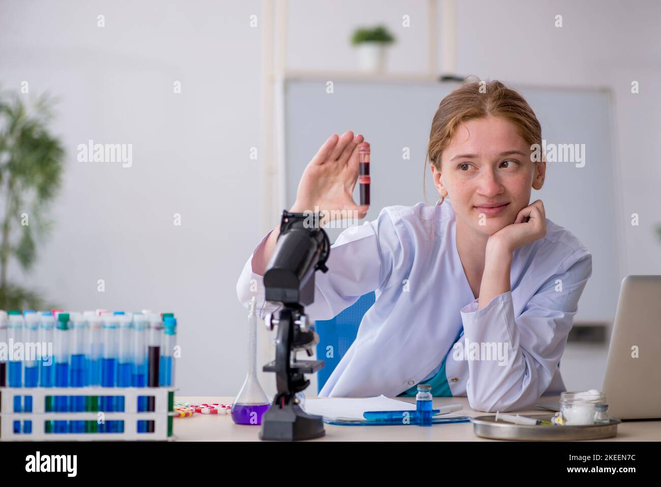 Young girl chemist in drugs synthesis concept Stock Photo - Alamy