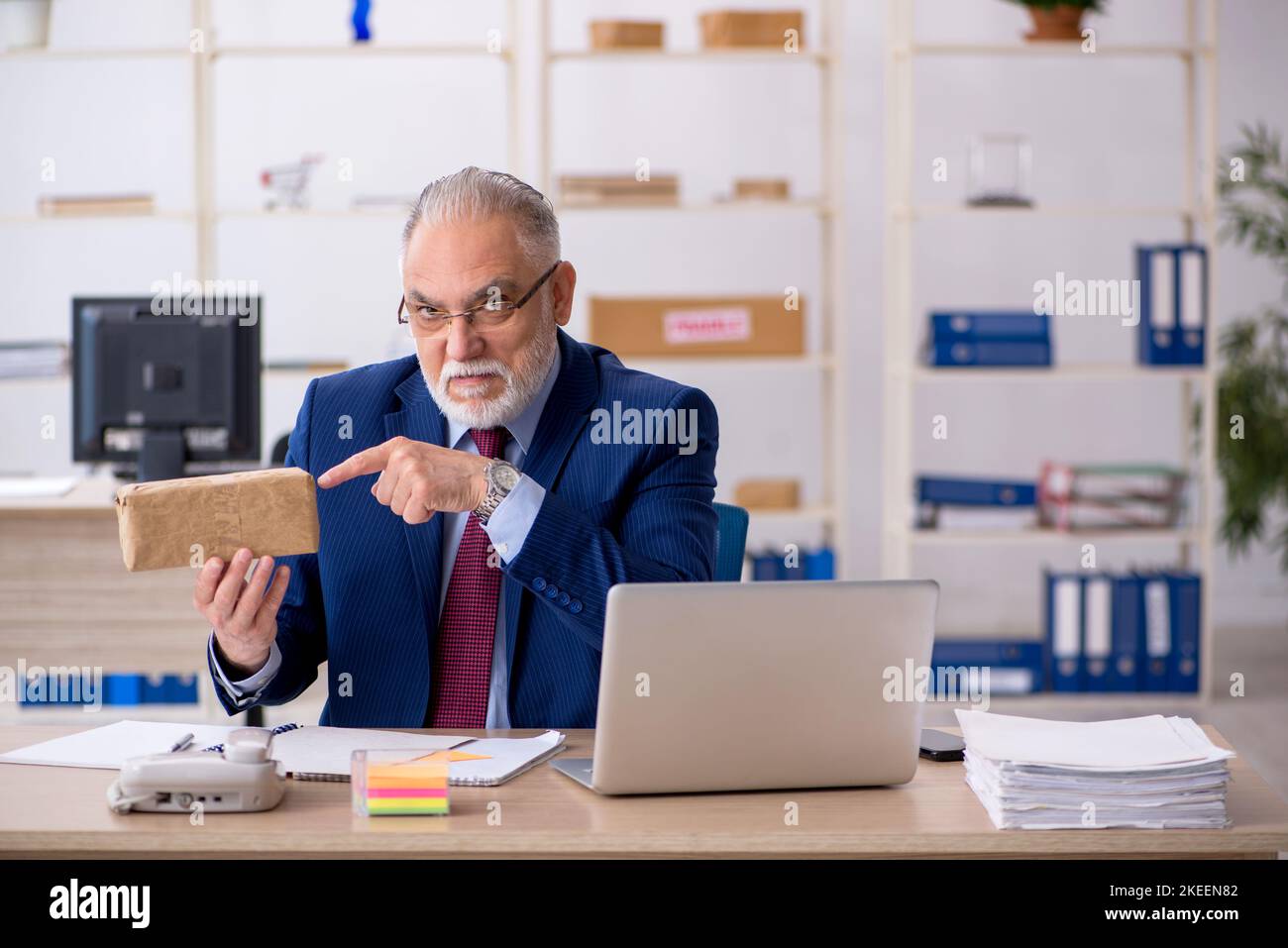 Old businessman employee ordering box via Internet Stock Photo - Alamy
