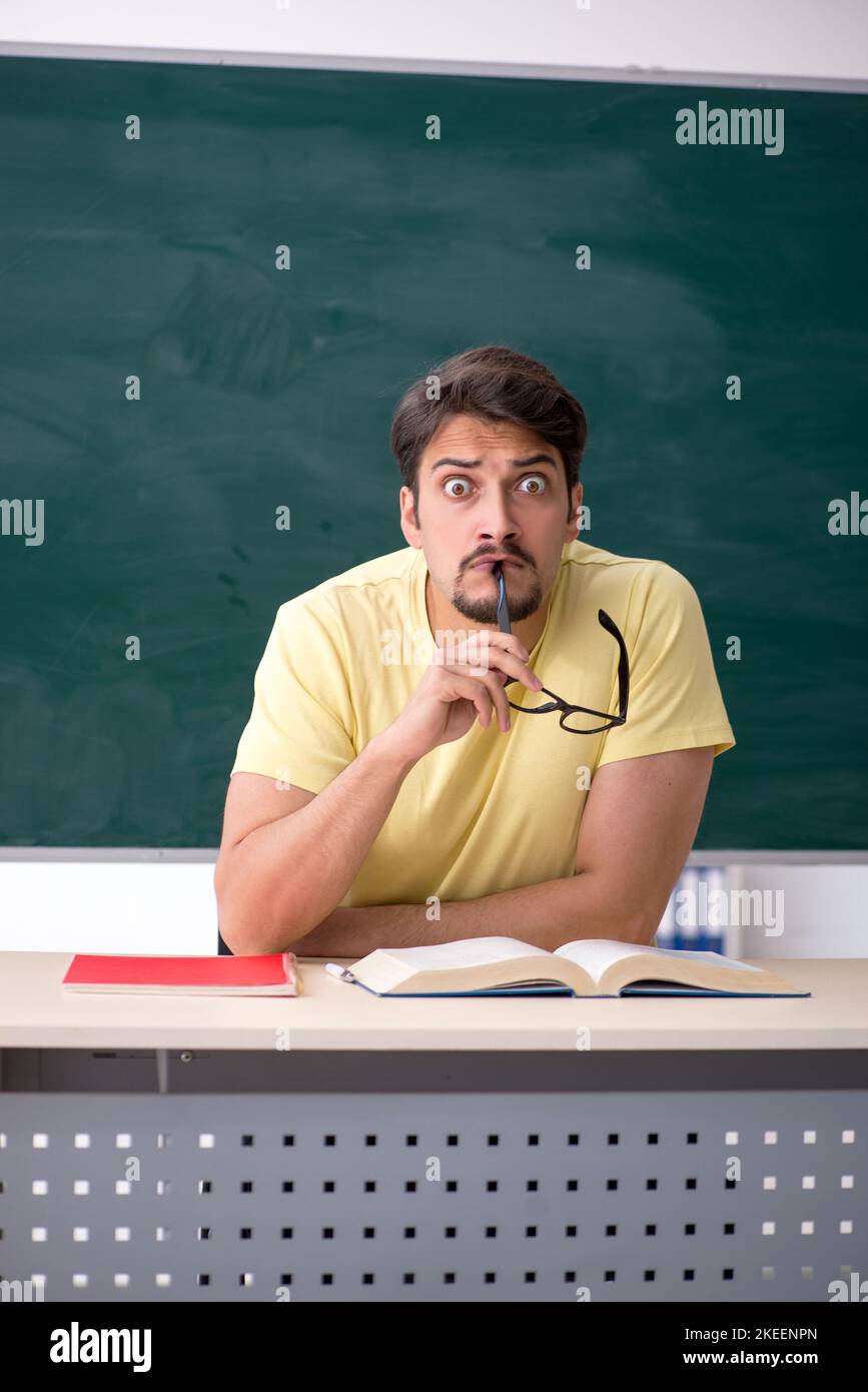 Young student in front of blackboard Stock Photo - Alamy