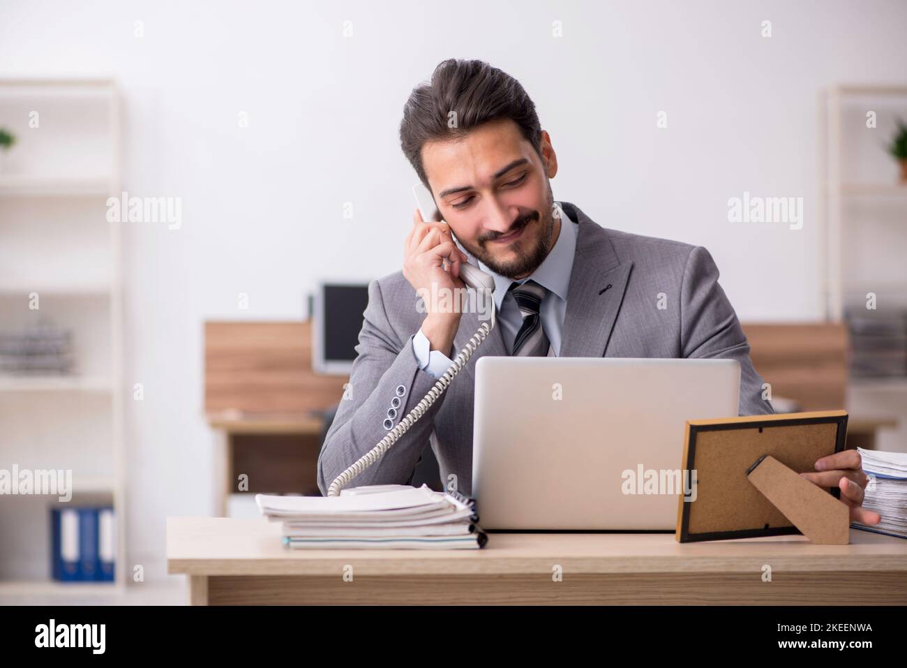 Young businessman employee missing girlfriend at workplace Stock Photo ...
