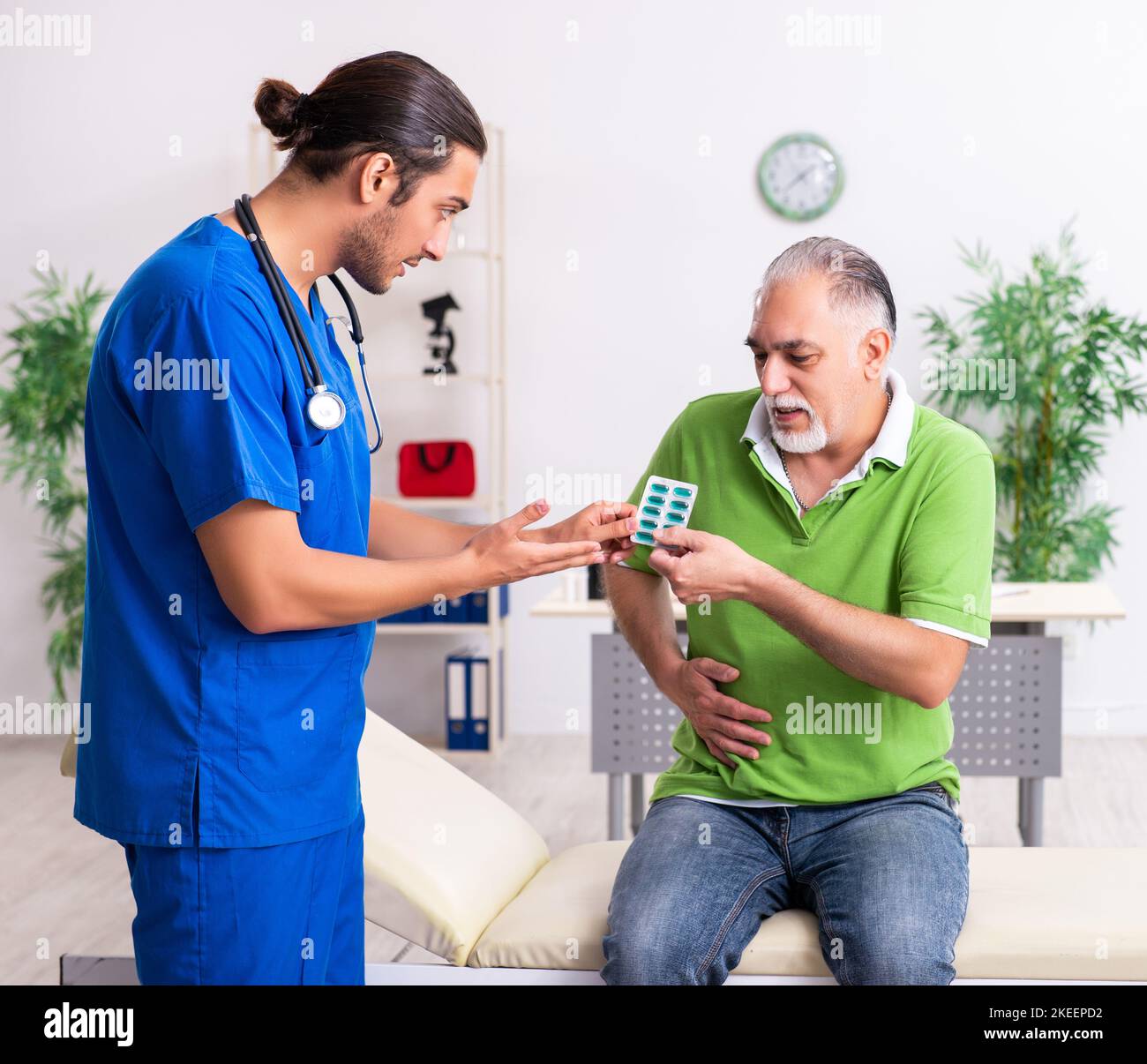 Senior man abdominal pain doctor hi-res stock photography and images ...