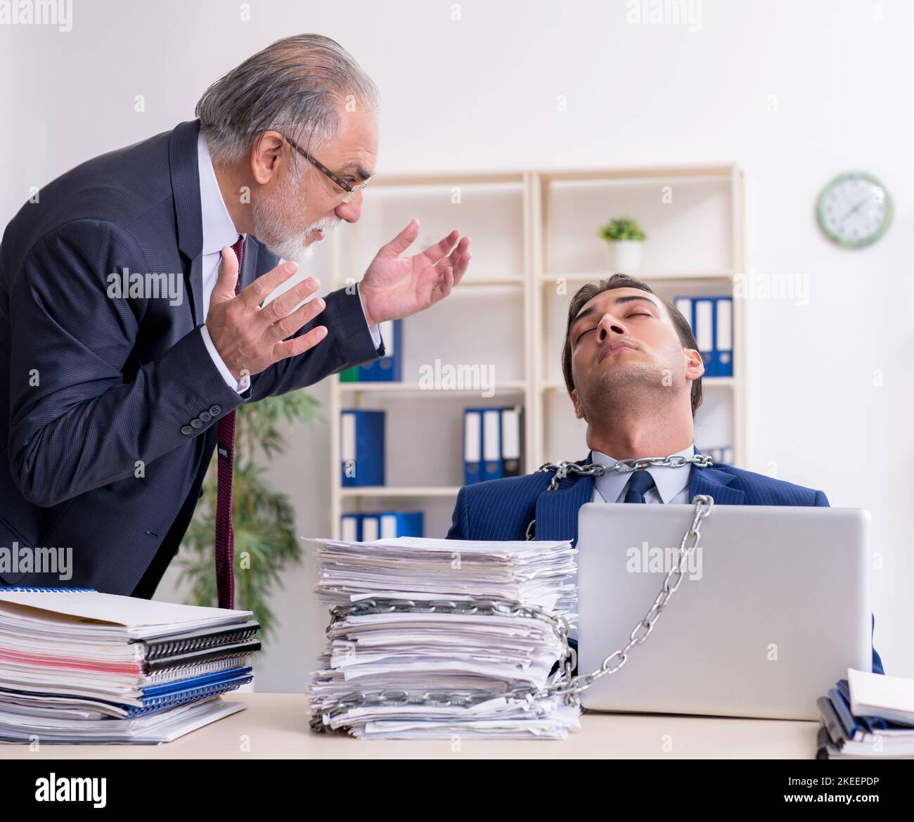 The old boss and young male employee in the office Stock Photo - Alamy