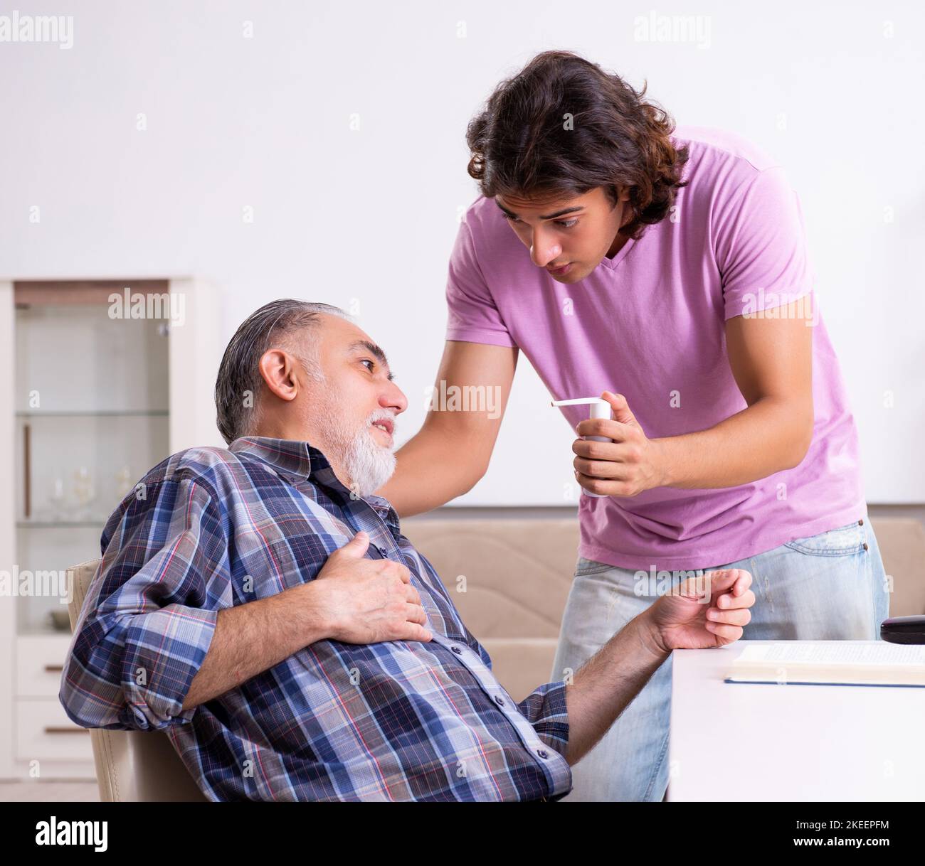 The young student and his old grandpa at home Stock Photo - Alamy
