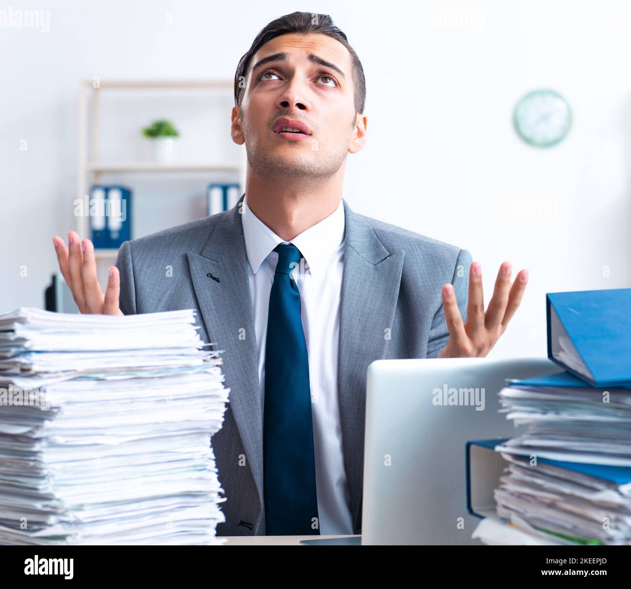The businessman with heavy paperwork workload Stock Photo - Alamy