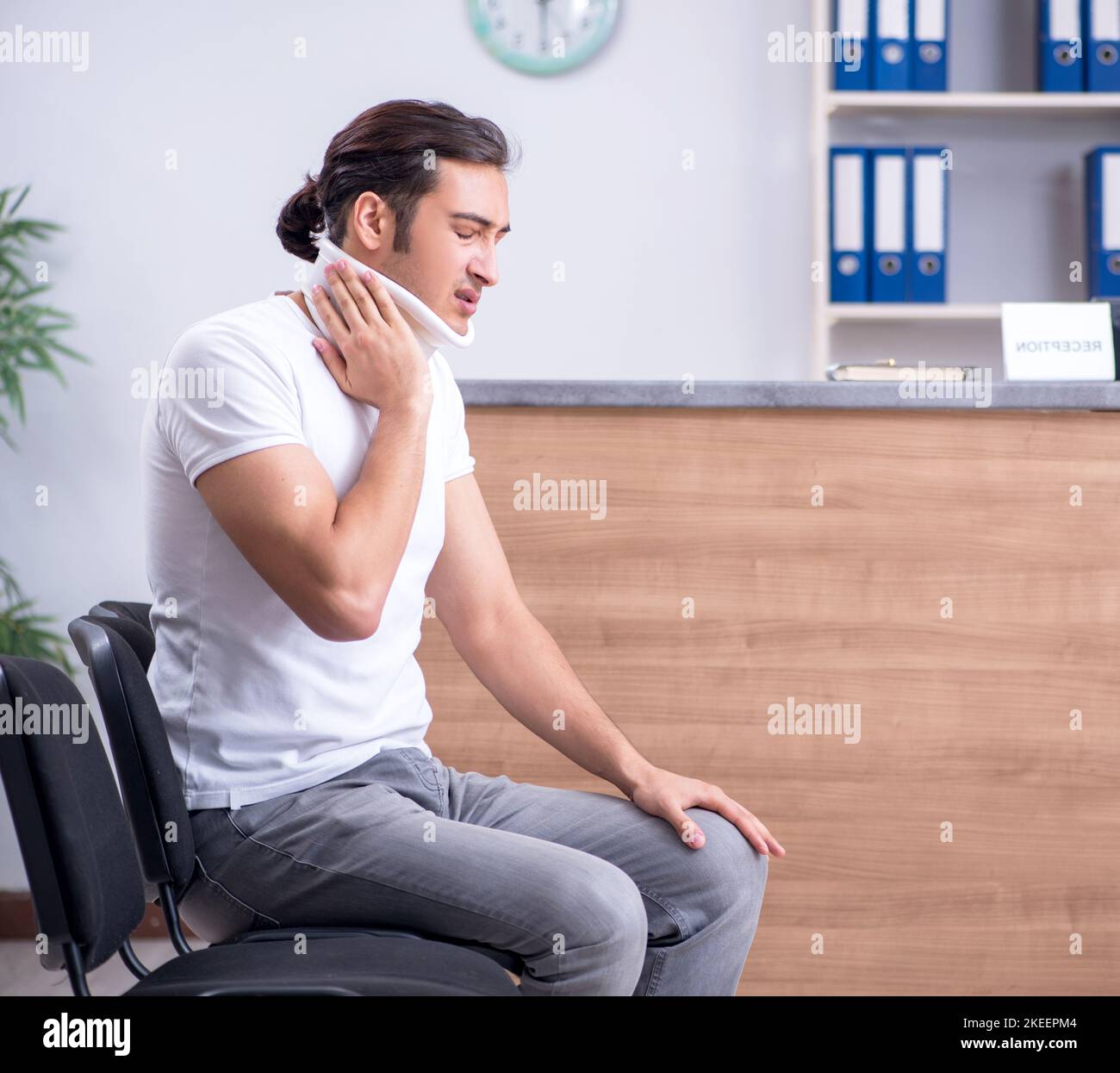 Clinic reception counter and young patient Stock Photo - Alamy