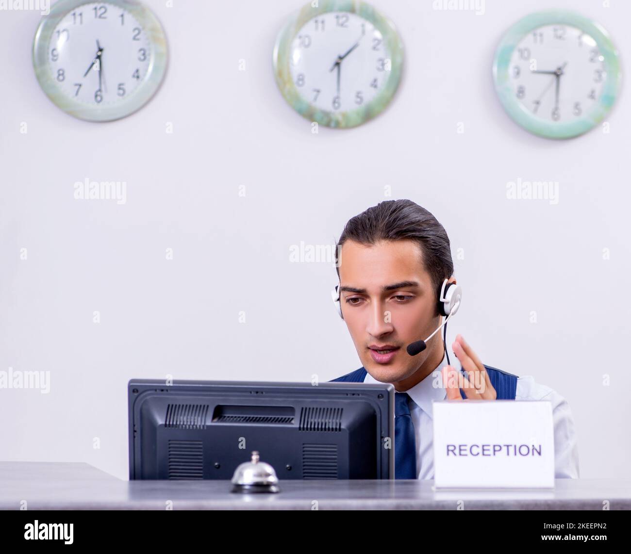 The young man receptionist at the hotel counter Stock Photo - Alamy