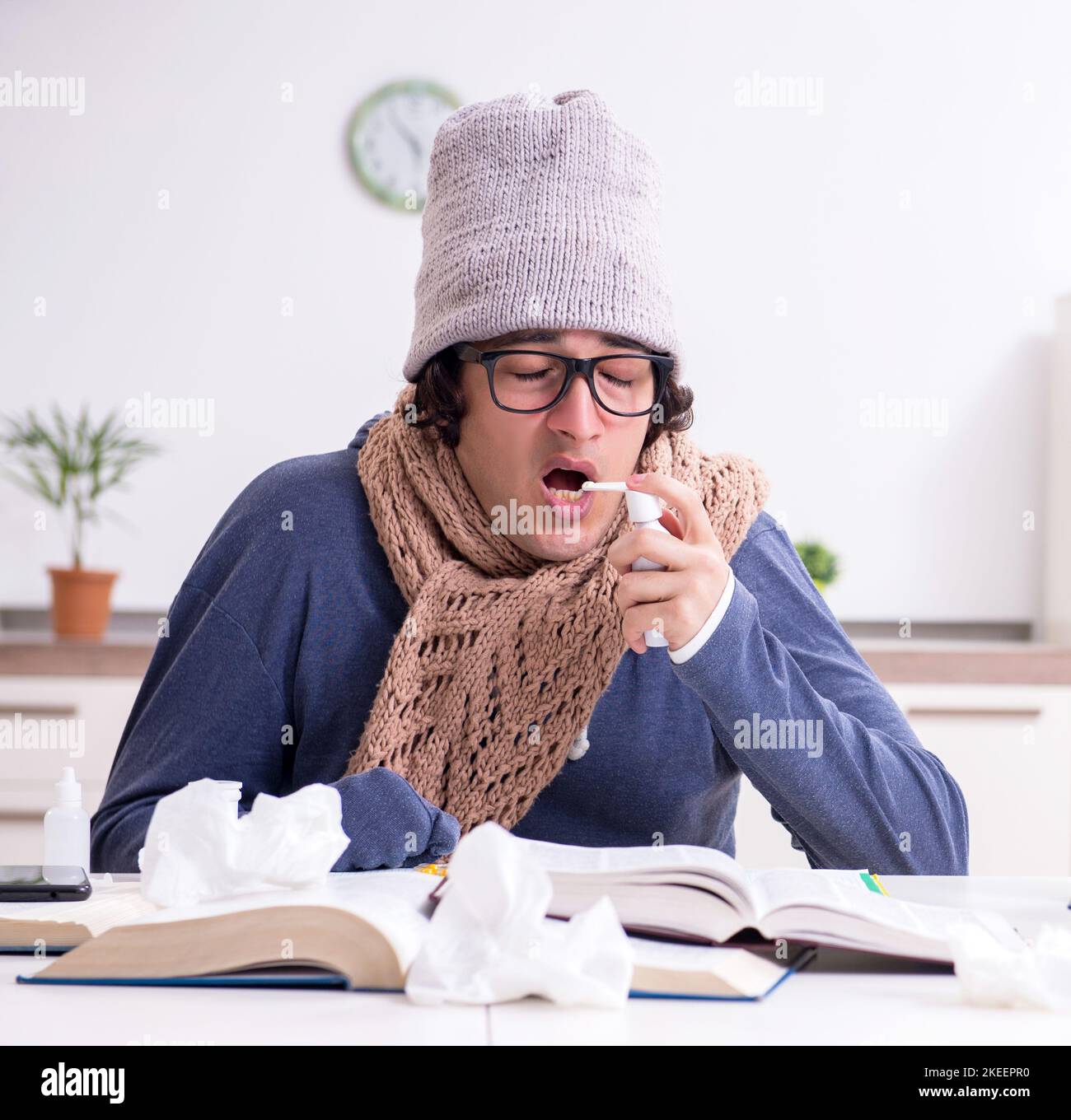 The sick male student suffering at home Stock Photo - Alamy
