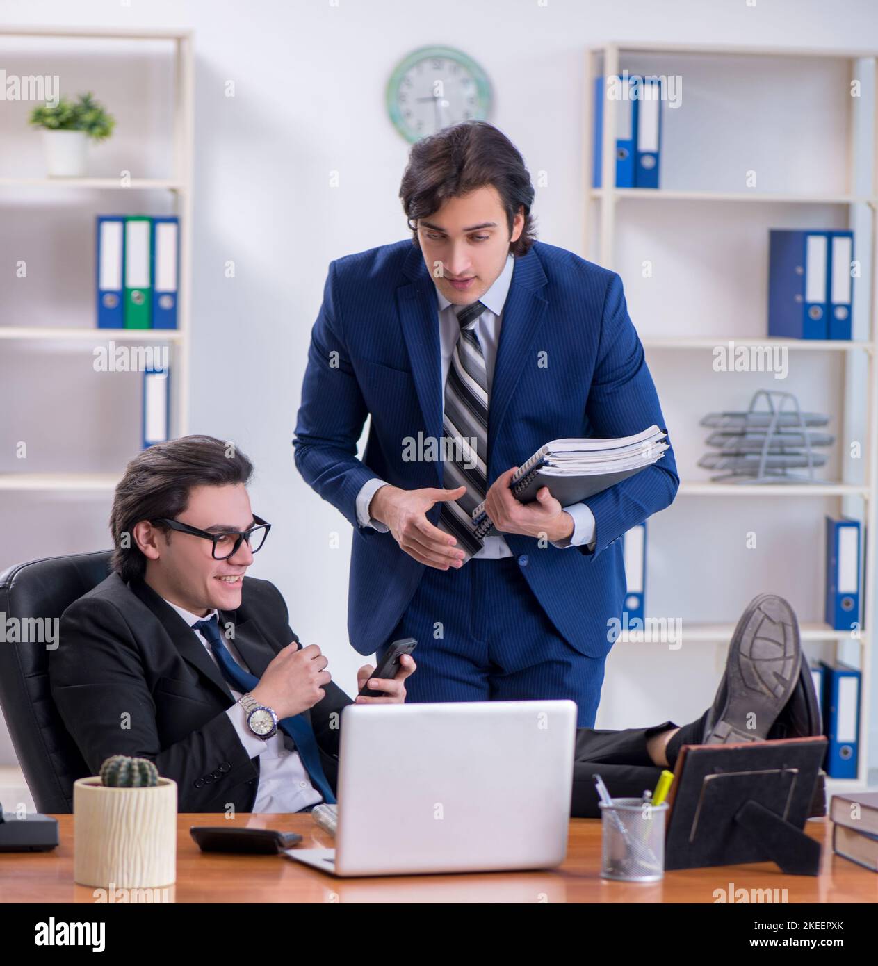 The boss and his male assistant working in the office Stock Photo - Alamy