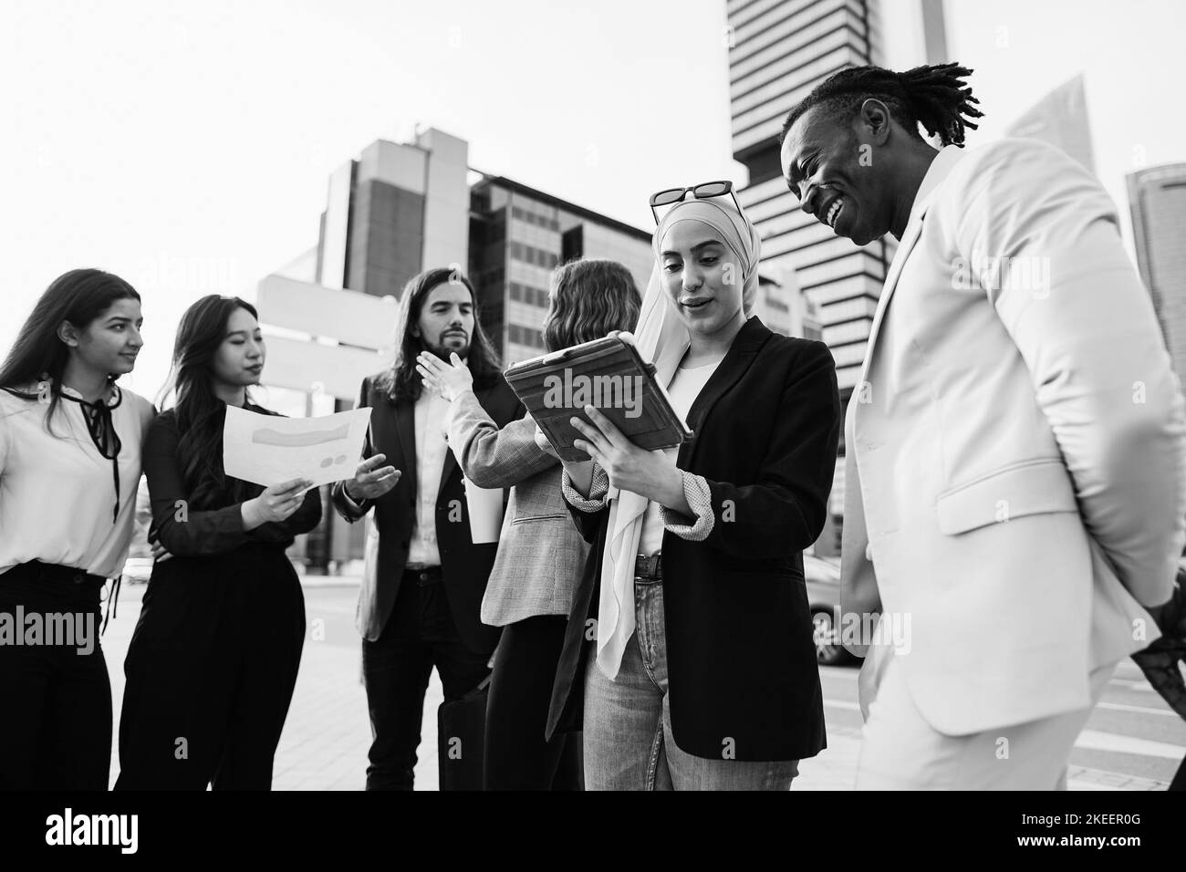 Multiracial business people working outdoor from office building ...