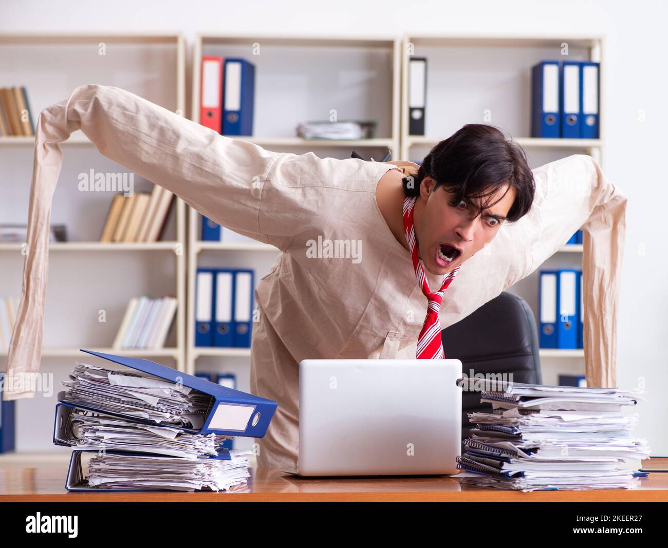 The crazy young man in straitjacket at the office Stock Photo - Alamy