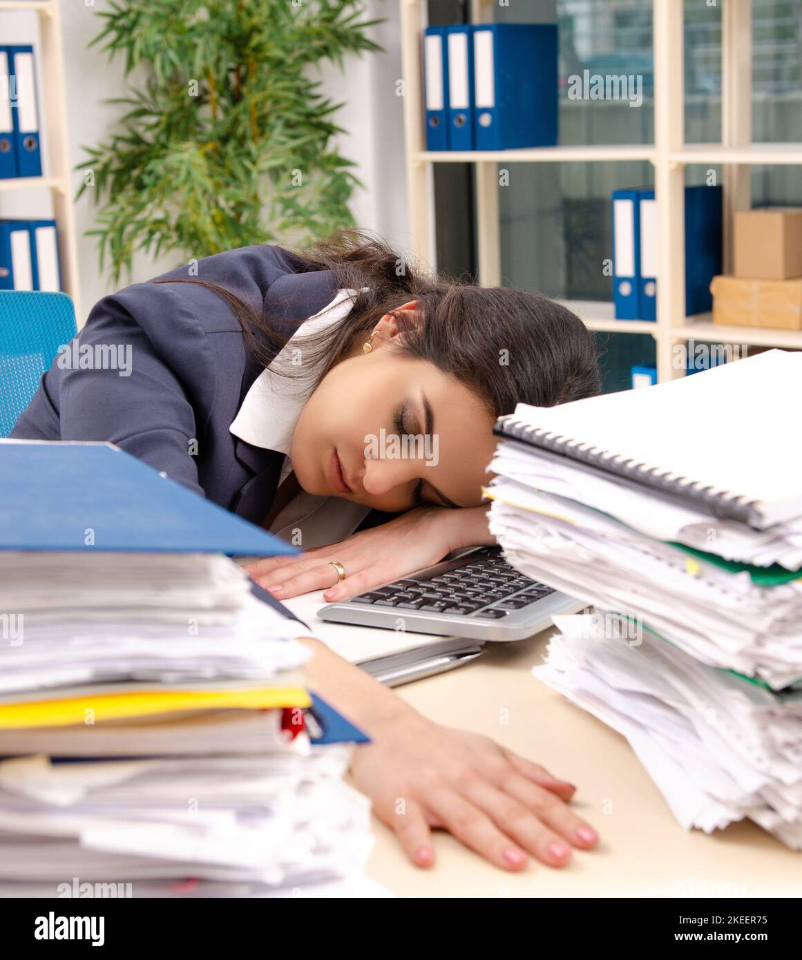 Female employee with too much work in the office Stock Photo - Alamy