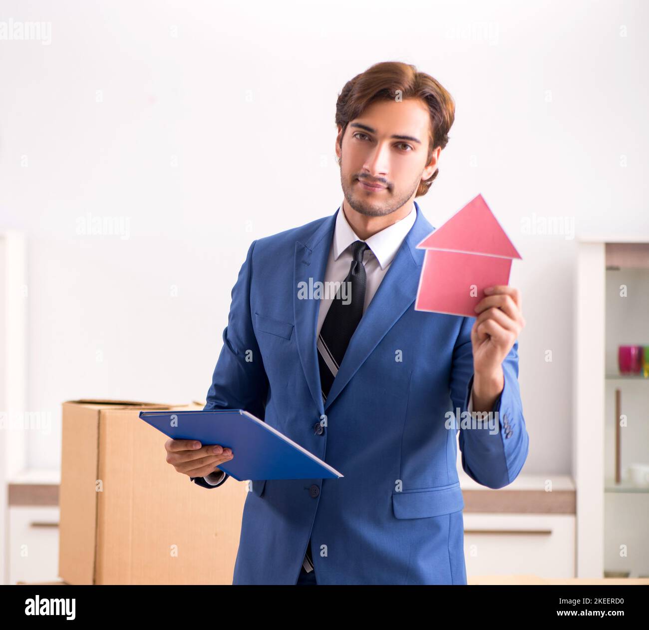 The young handsome realtor selling flat Stock Photo - Alamy