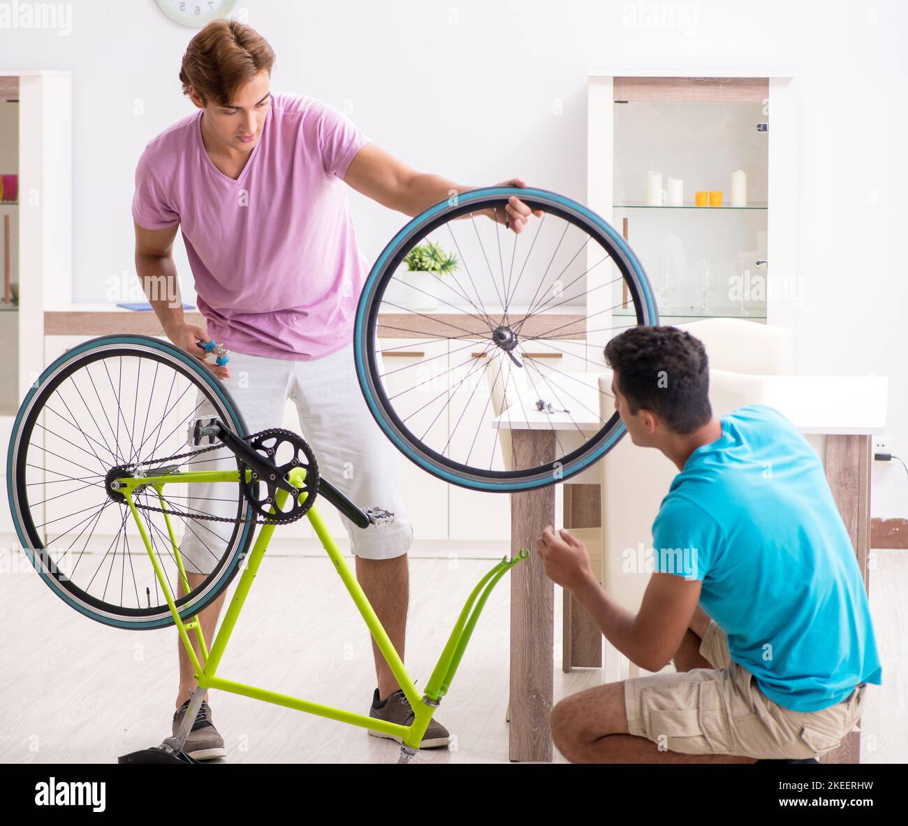 The man repairing his broken bicycle Stock Photo - Alamy